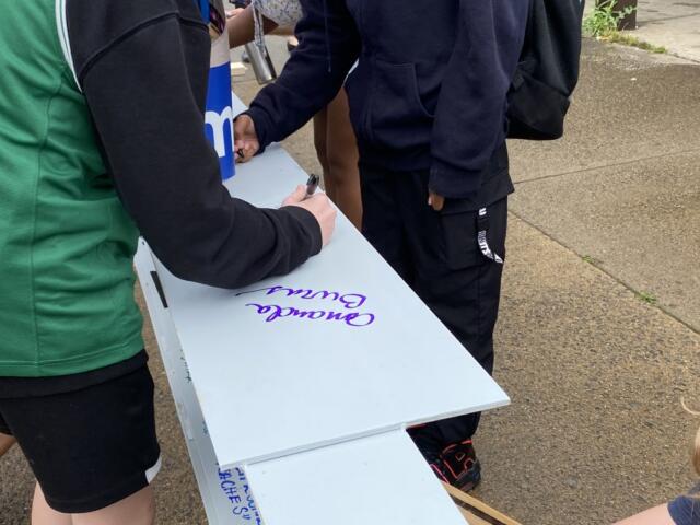 Middle school students and staff sign steel beam for new academic ...